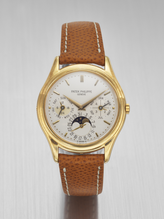 PATEK PHILIPPE. A RARE AND ELEGANT 18K GOLD AUTOMATIC PERPETUAL ...