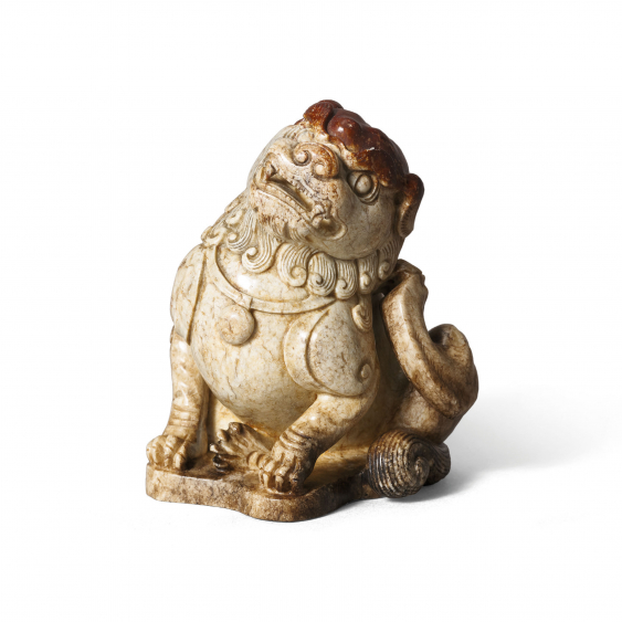 A CHICKEN-BONE JADE MYTHICAL LION