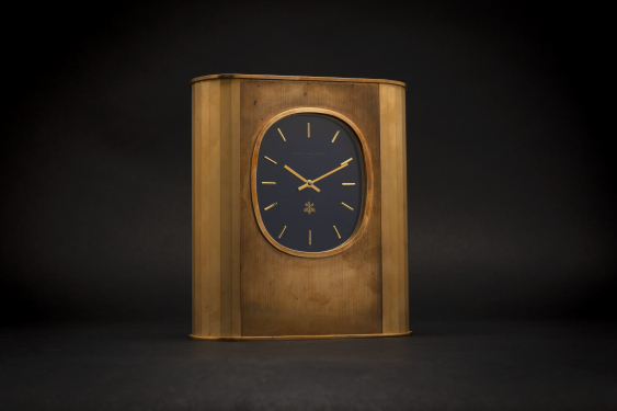 PATEK PHILIPPE, SOLAR-POWERED DESK CLOCK, GILT BRASS, “ELLIPSE D’OR ...
